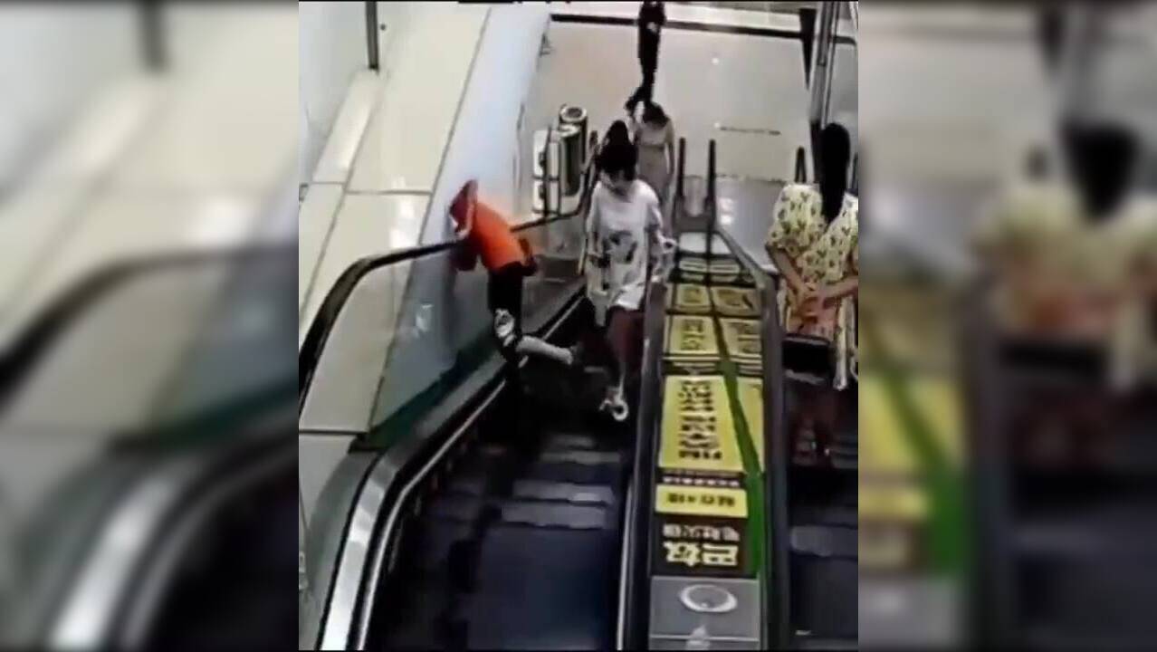 viral video boy gets stuck between escalator and wall horrific video ...